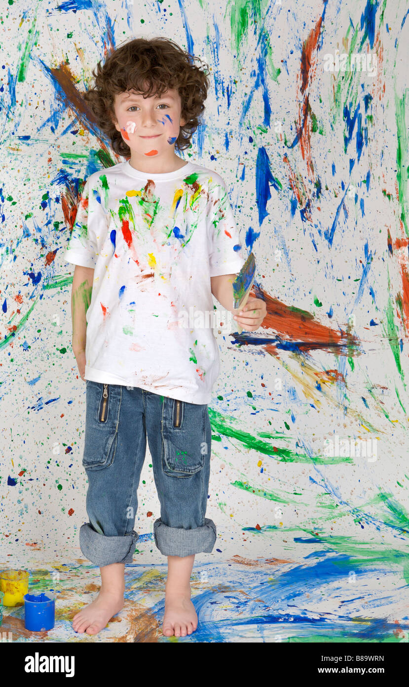 Handsome boy playing with painting with the background painted Stock ...