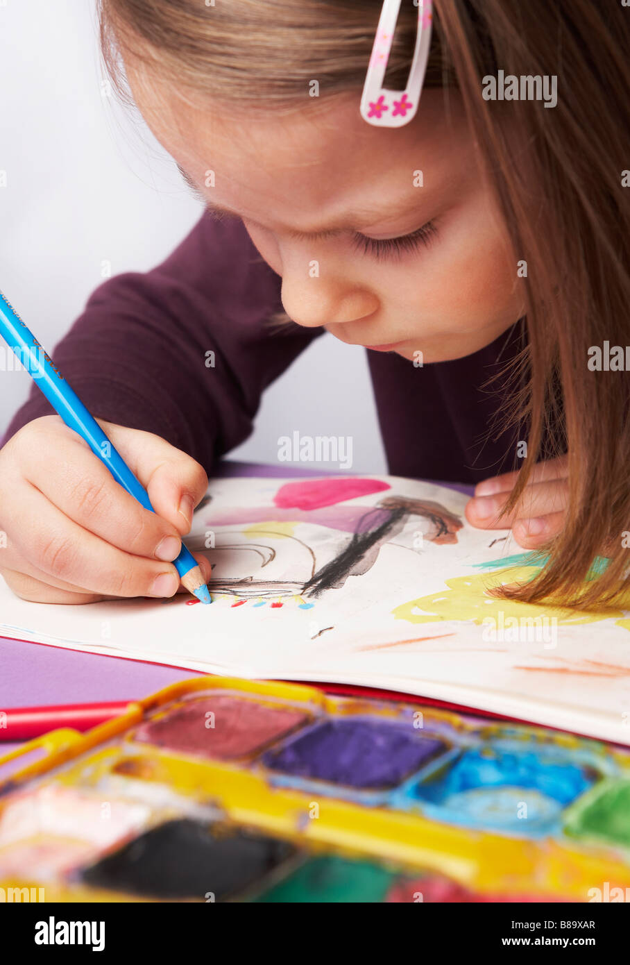 child concentrated on drawing a picture Stock Photo - Alamy