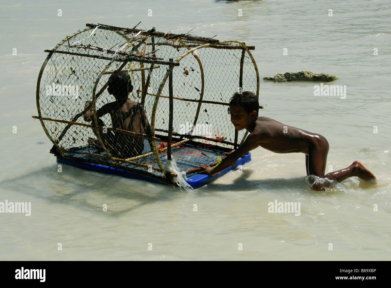 Moken sea gypsy boys enjoy playing with the fish net,Surin Island ...