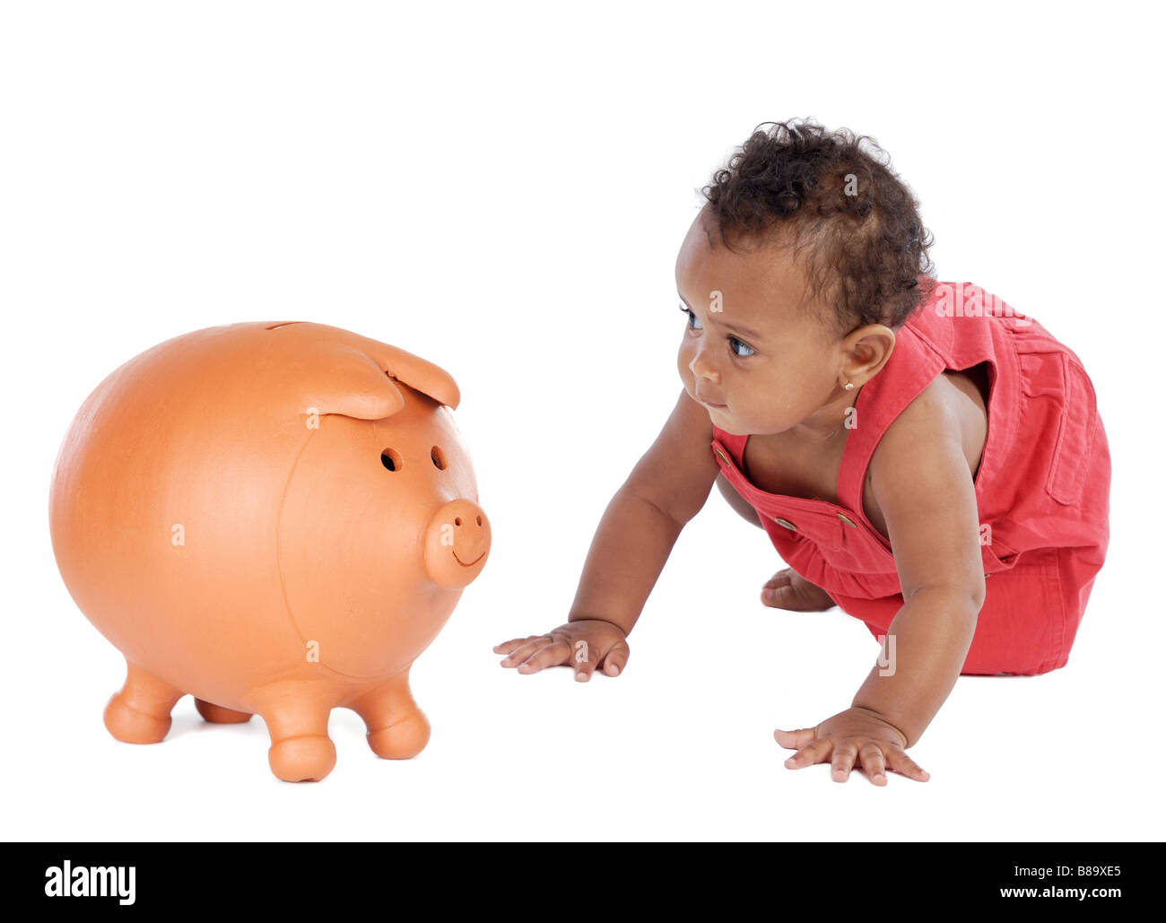 African beautiful baby crawling towards a piggy bank Stock Photo - Alamy
