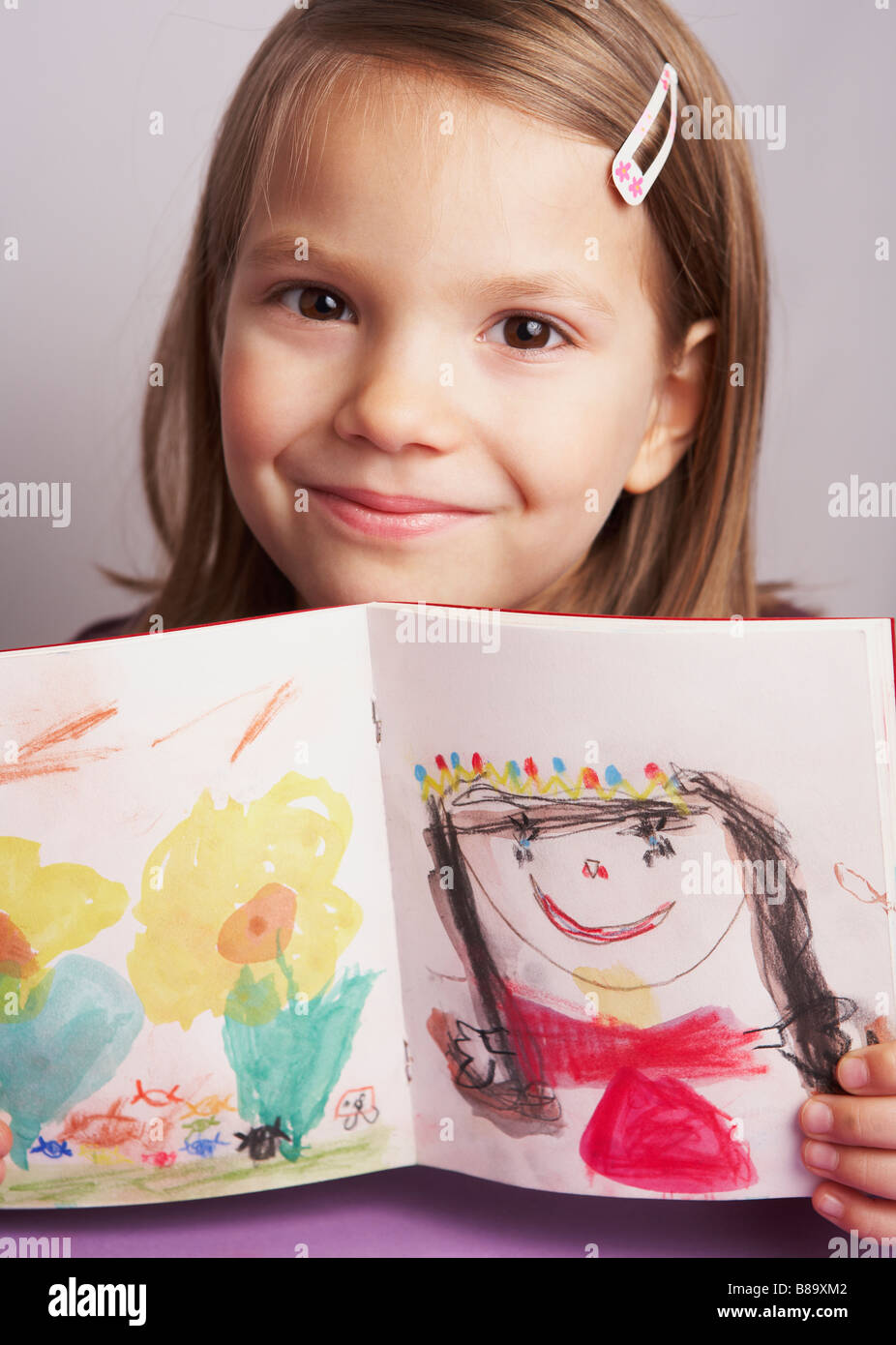 young girl presenting a drawing Stock Photo - Alamy