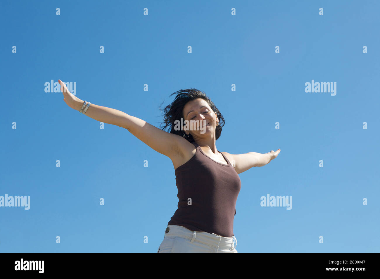 Photo of woman relaxing with sky background Stock Photo - Alamy