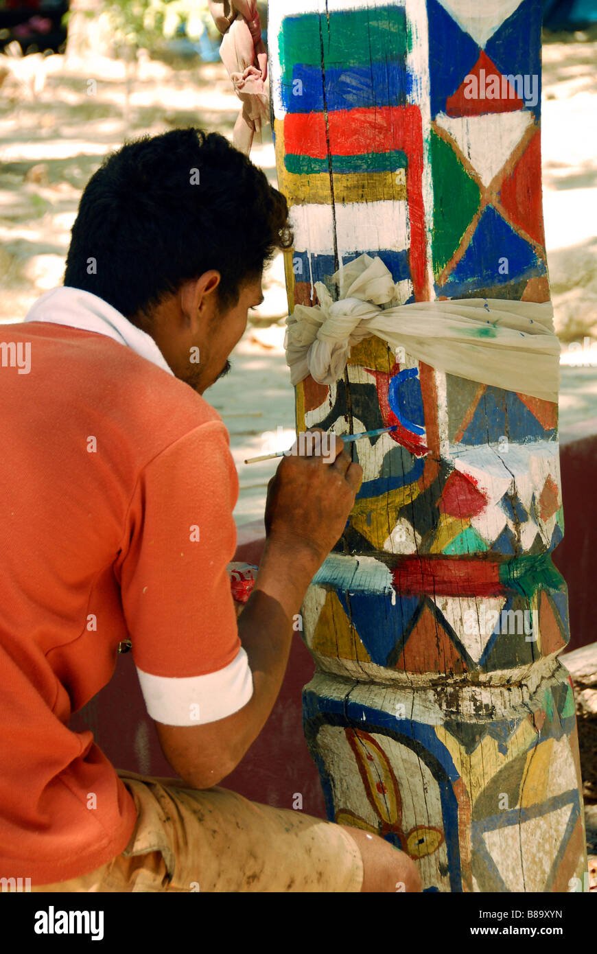 Moken sea gypsy man painting Lorbow image (Moken's god) before annual ...