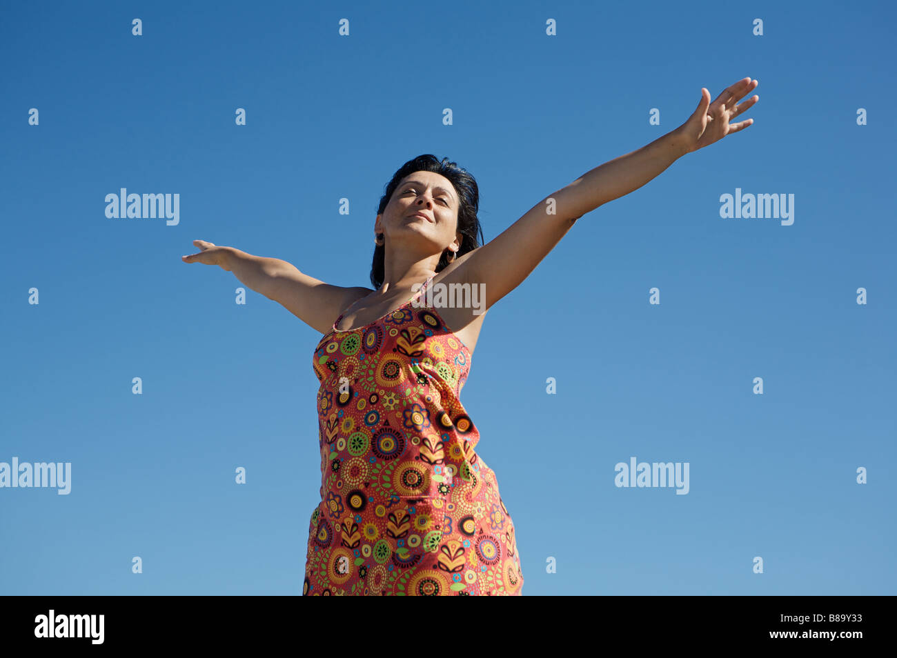 Photo of woman relaxing with sky background Stock Photo - Alamy