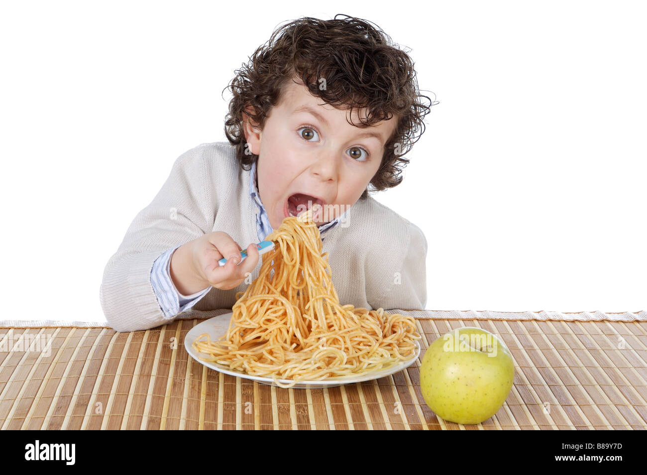 Adorable child hungry at the time of eating a over white background ...