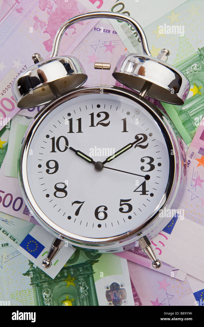The time is money Clock with money background Stock Photo - Alamy
