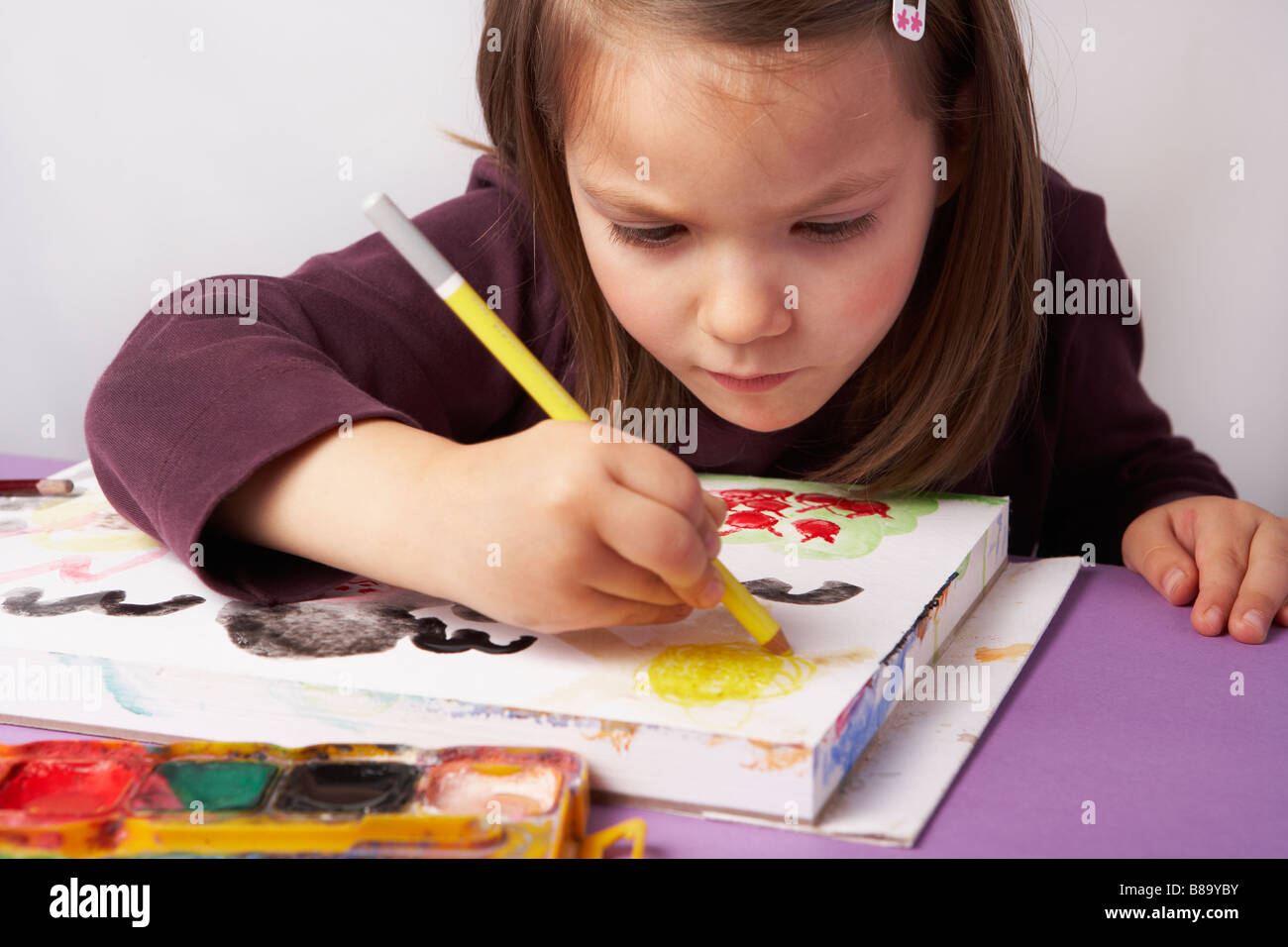 child concentrated on drawing a picture Stock Photo - Alamy