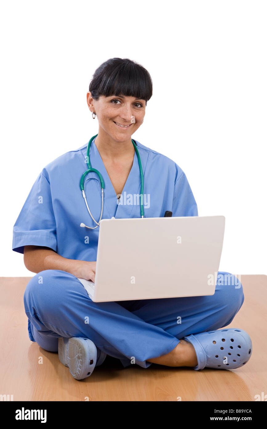 Woman doctor sitting with laptop a over white background Stock Photo ...