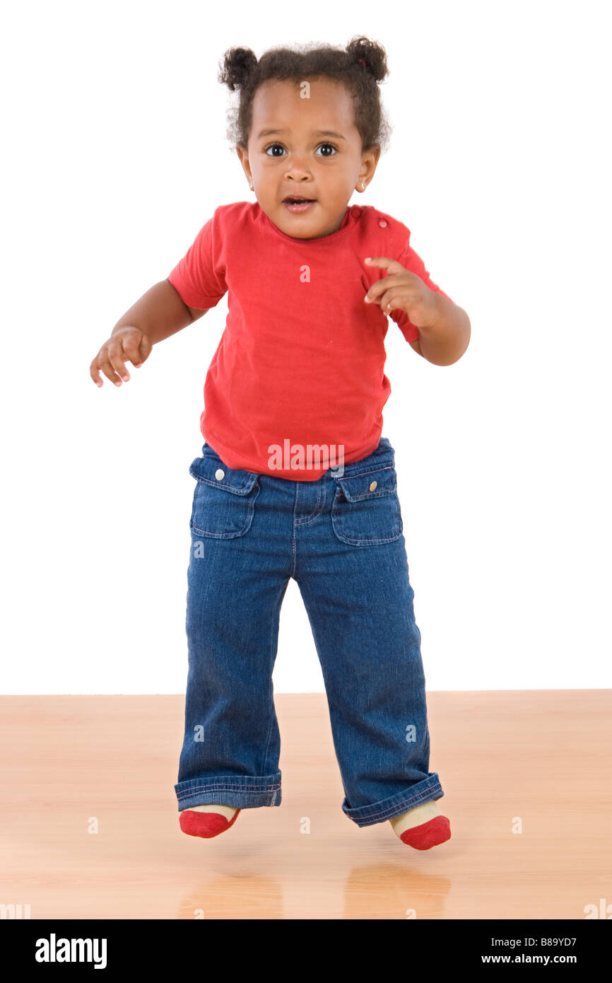 Adorable and beautiful african baby jumping a over wooden floor Stock ...