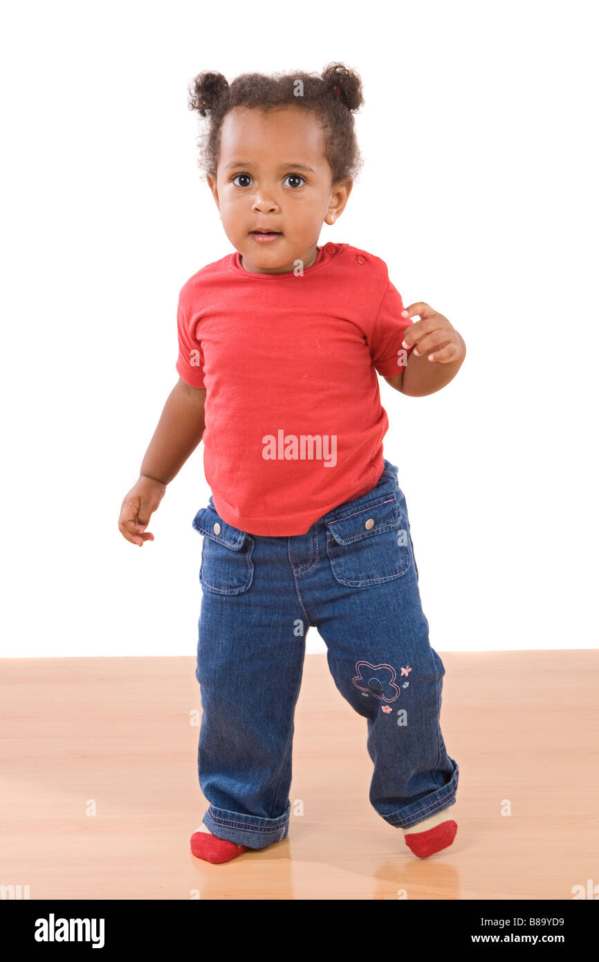 Adorable african baby standing over wooden floor Stock Photo - Alamy