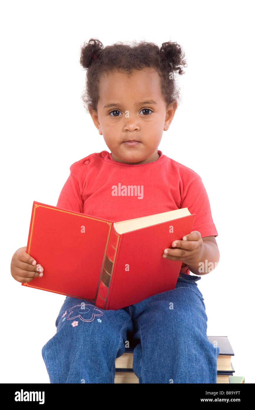 Adorable african baby reading sitting on a pile of books on a over ...