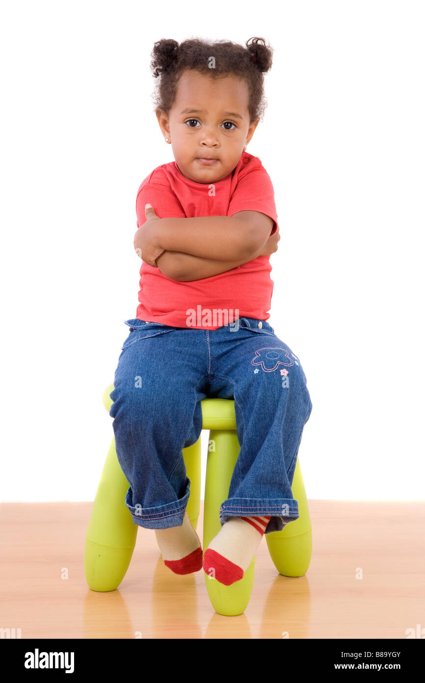 Adorable african baby sitting on green stool on a over white background ...