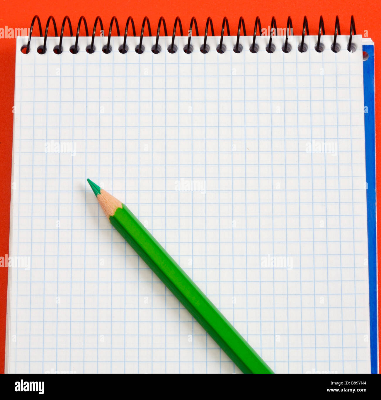 pencil and notebook over a red background Stock Photo - Alamy