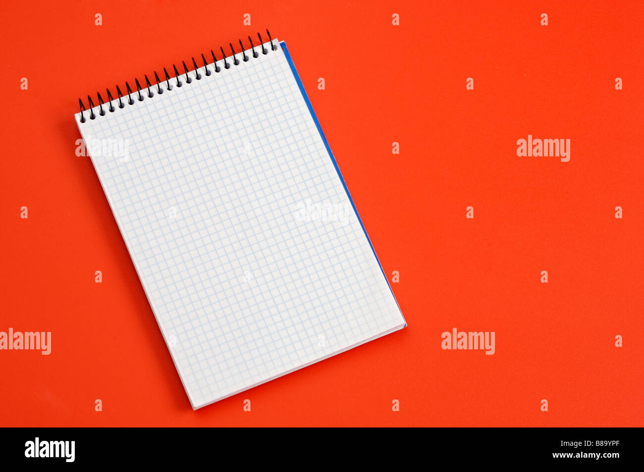 photo of a notebook over a red background Stock Photo - Alamy