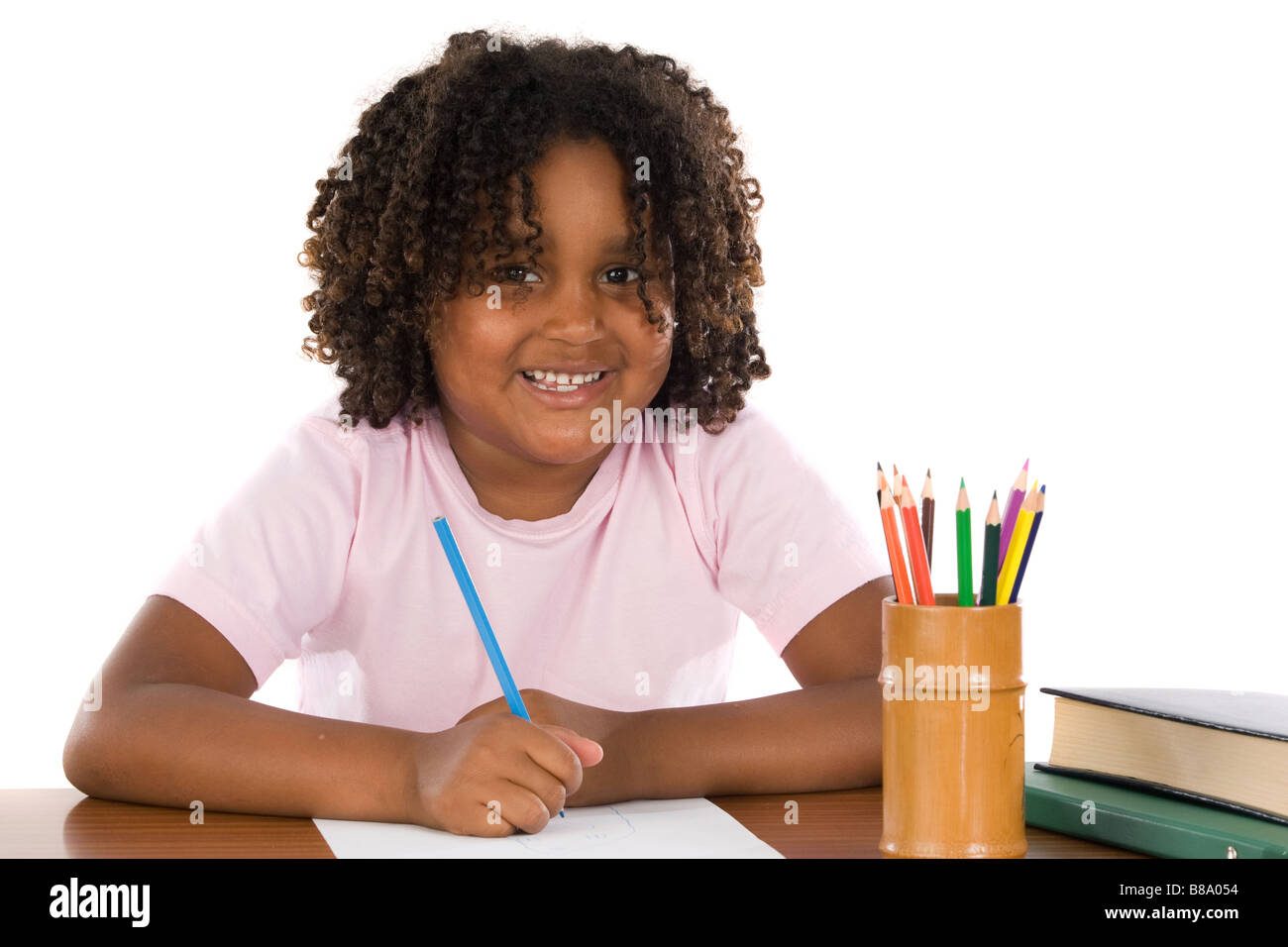Adorable african girl writing a over white background Stock Photo - Alamy
