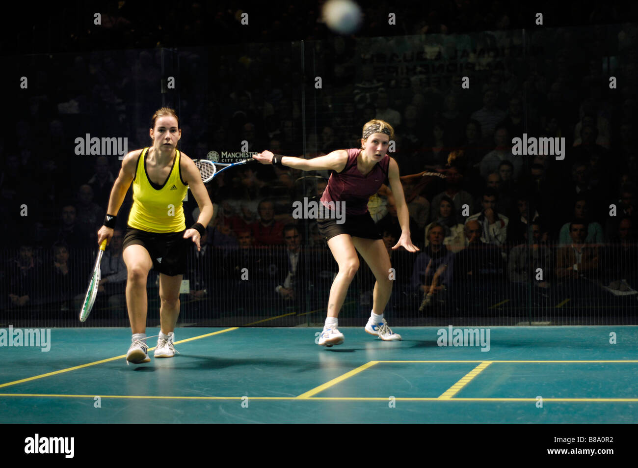 alison waters plays a backhand shot in the squash national championship ...