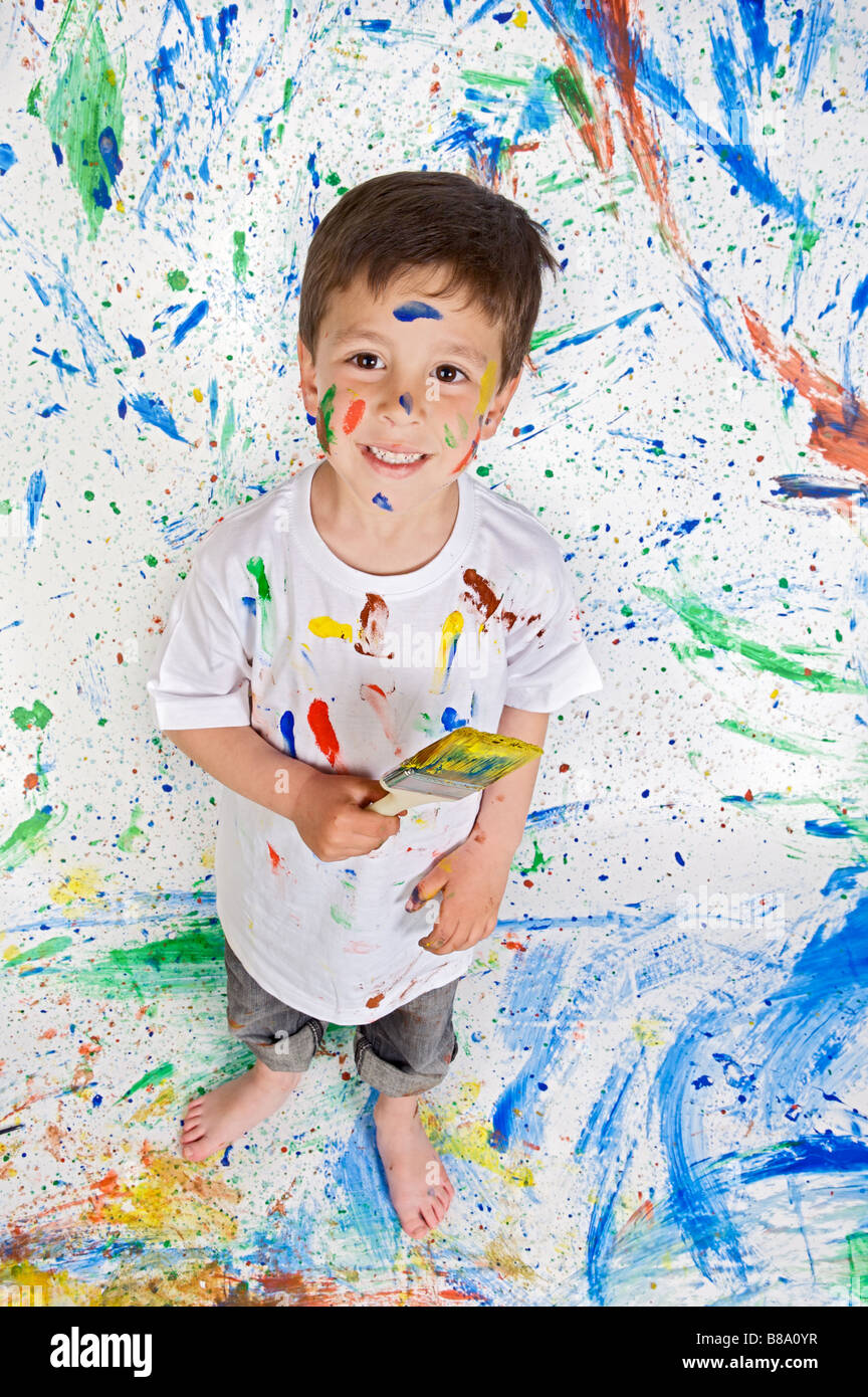 Handsome boy playing with painting with the background painted Stock ...