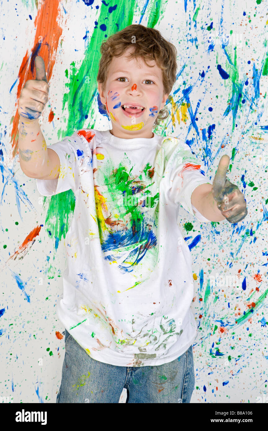 Boy no teeth playing with painting with the background painted Stock ...