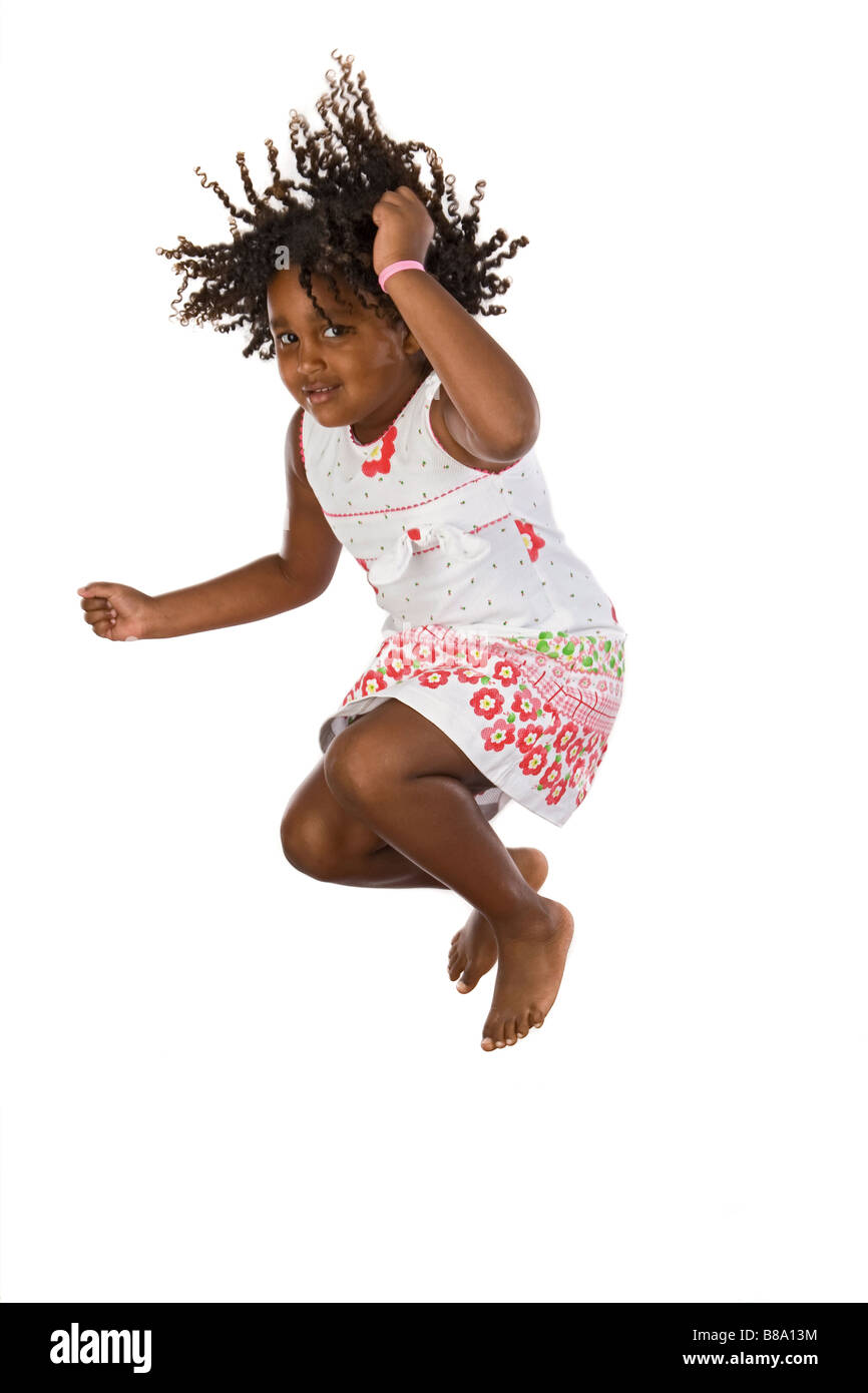Adorable african girl jumping a over white background Stock Photo - Alamy