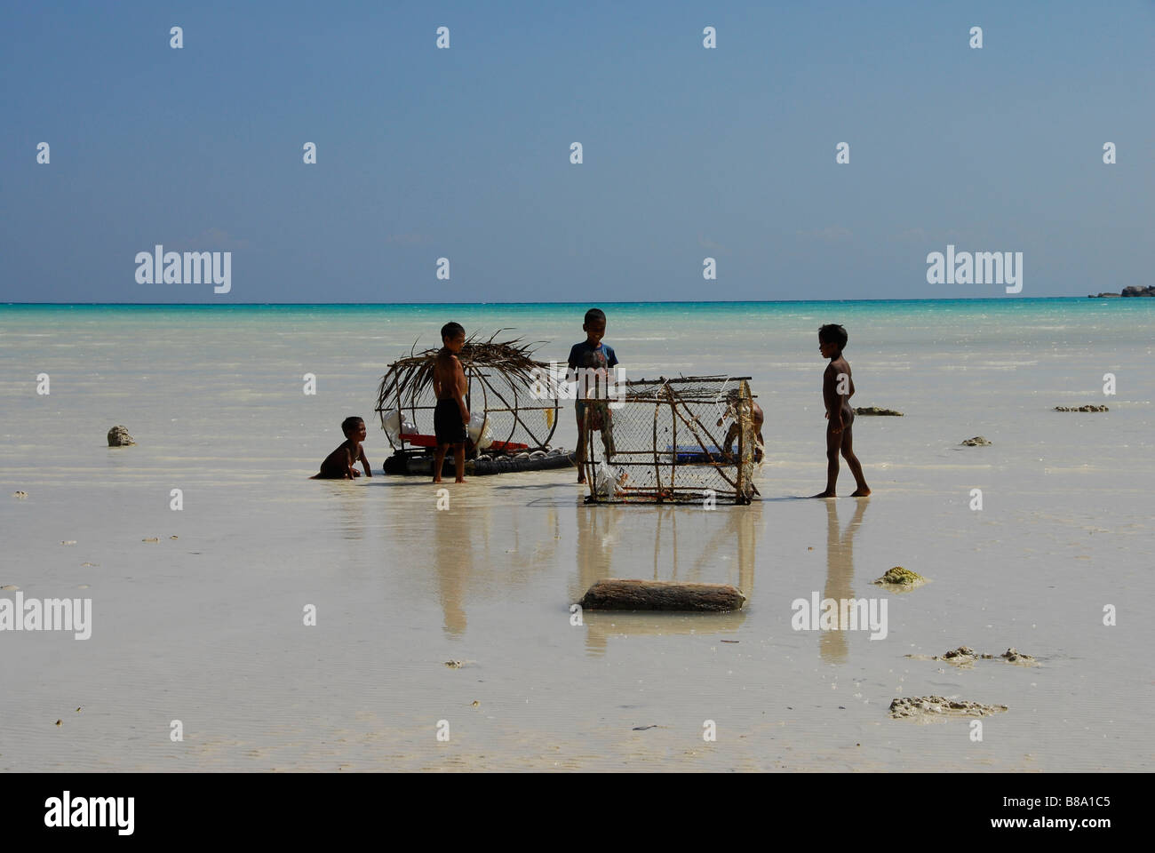 Moken sea gypsy boys enjoy playing by the beach near thier village ...