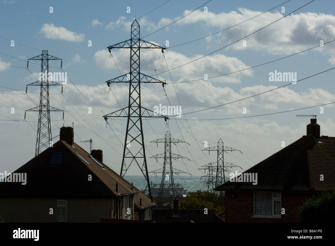 Pylons loom over a residential street in Brighton on the Sussex coast ...