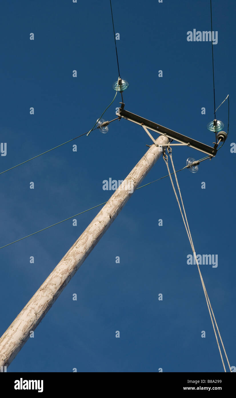 Telegraph pole against blue sky Stock Photo - Alamy