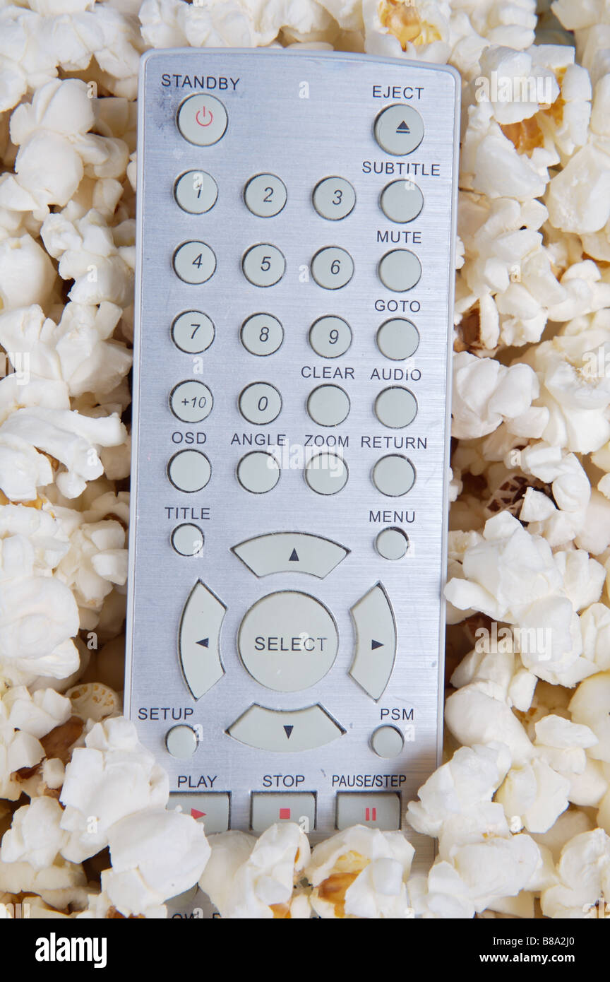 Popcorn and remote control prepared to see cinema Stock Photo - Alamy