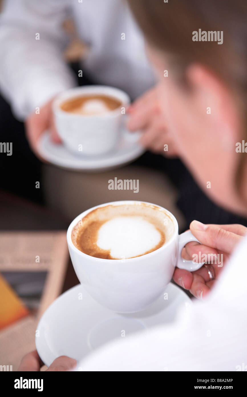 Two people sat drinking coffee Stock Photo - Alamy