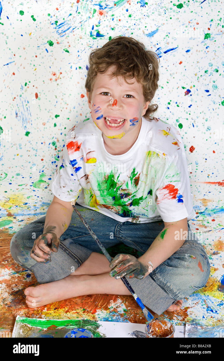 Boy no teeth playing with painting with the background painted Stock ...