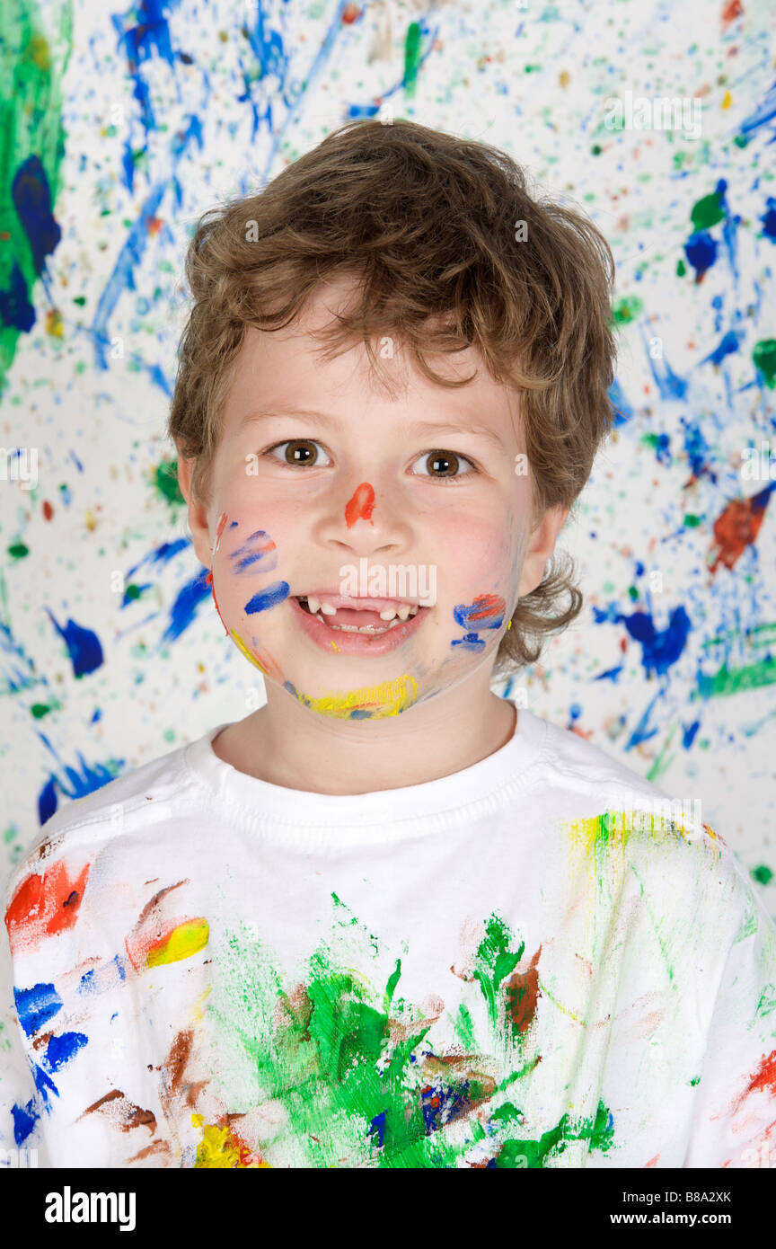 Boy no teeth playing with painting with the background painted Stock ...
