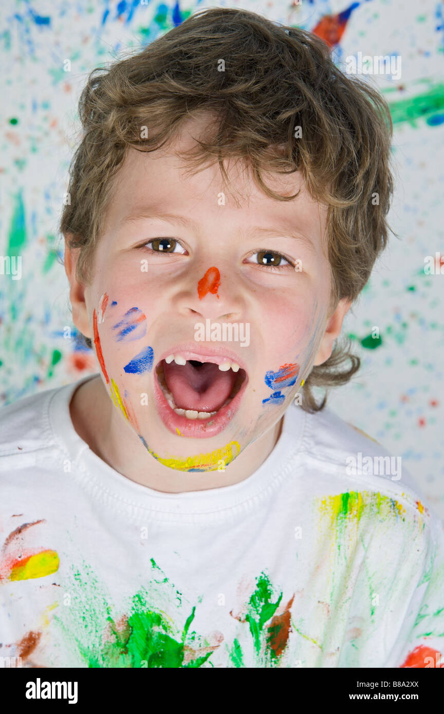 boy no teeth playing with painting with the background painted Stock ...