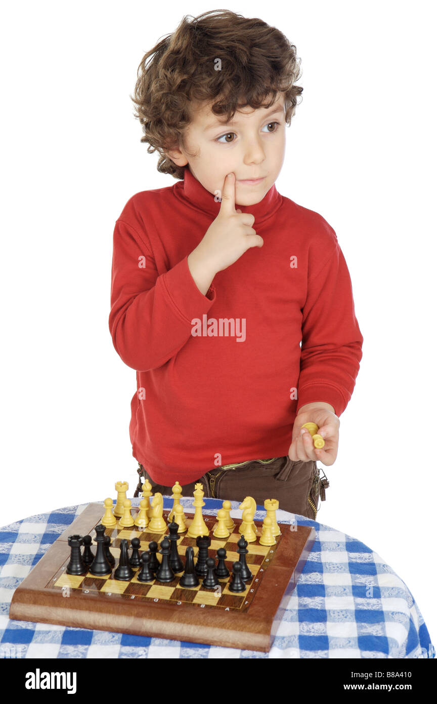 Photo of an adorable boy playing the chess Stock Photo - Alamy