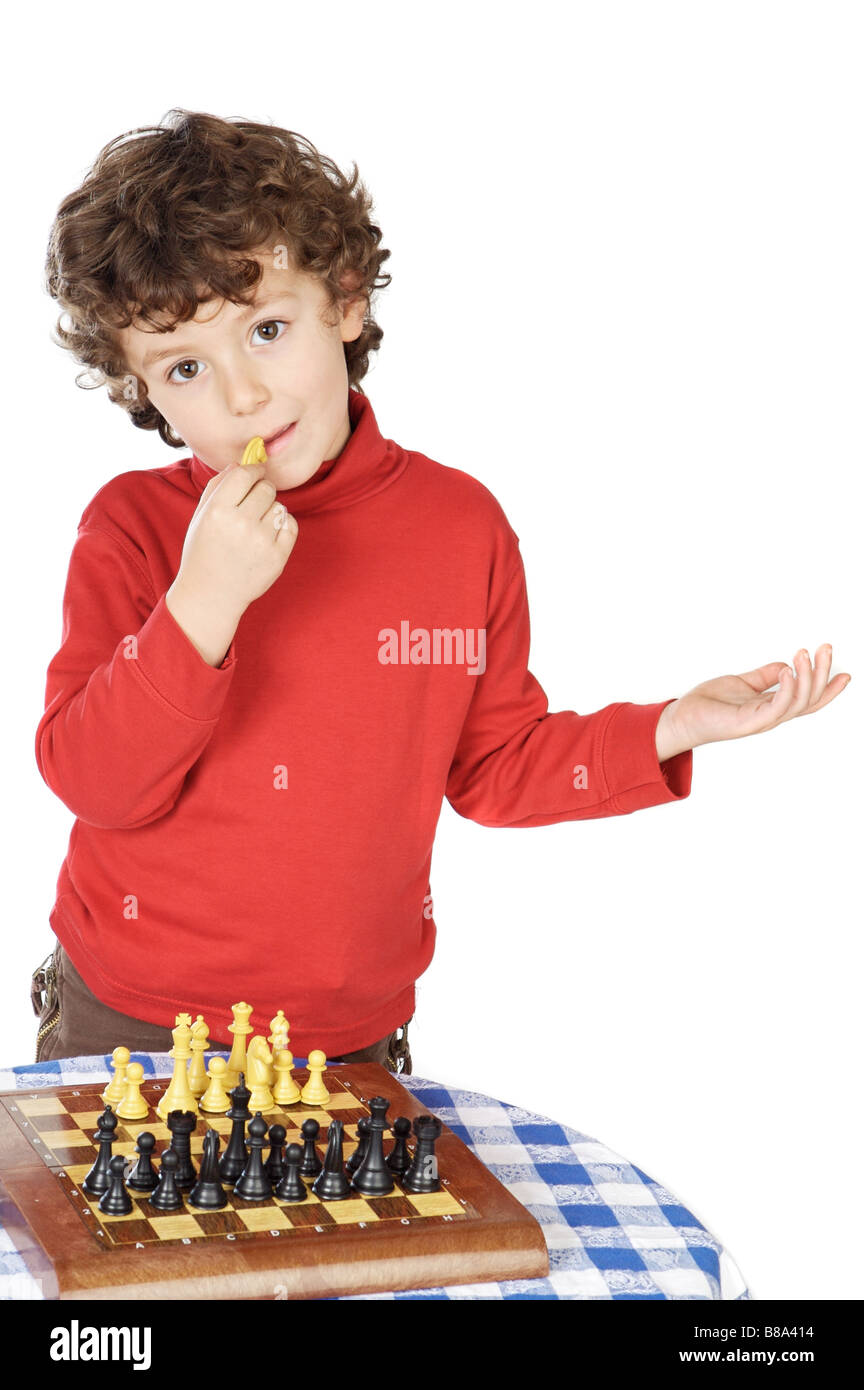 Photo of an adorable boy playing the chess Stock Photo - Alamy