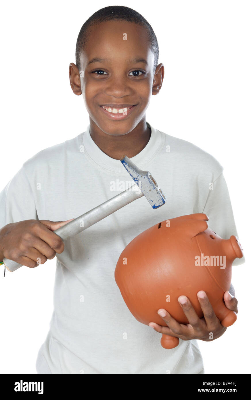 Boy with a hammer breaking a money box Stock Photo - Alamy