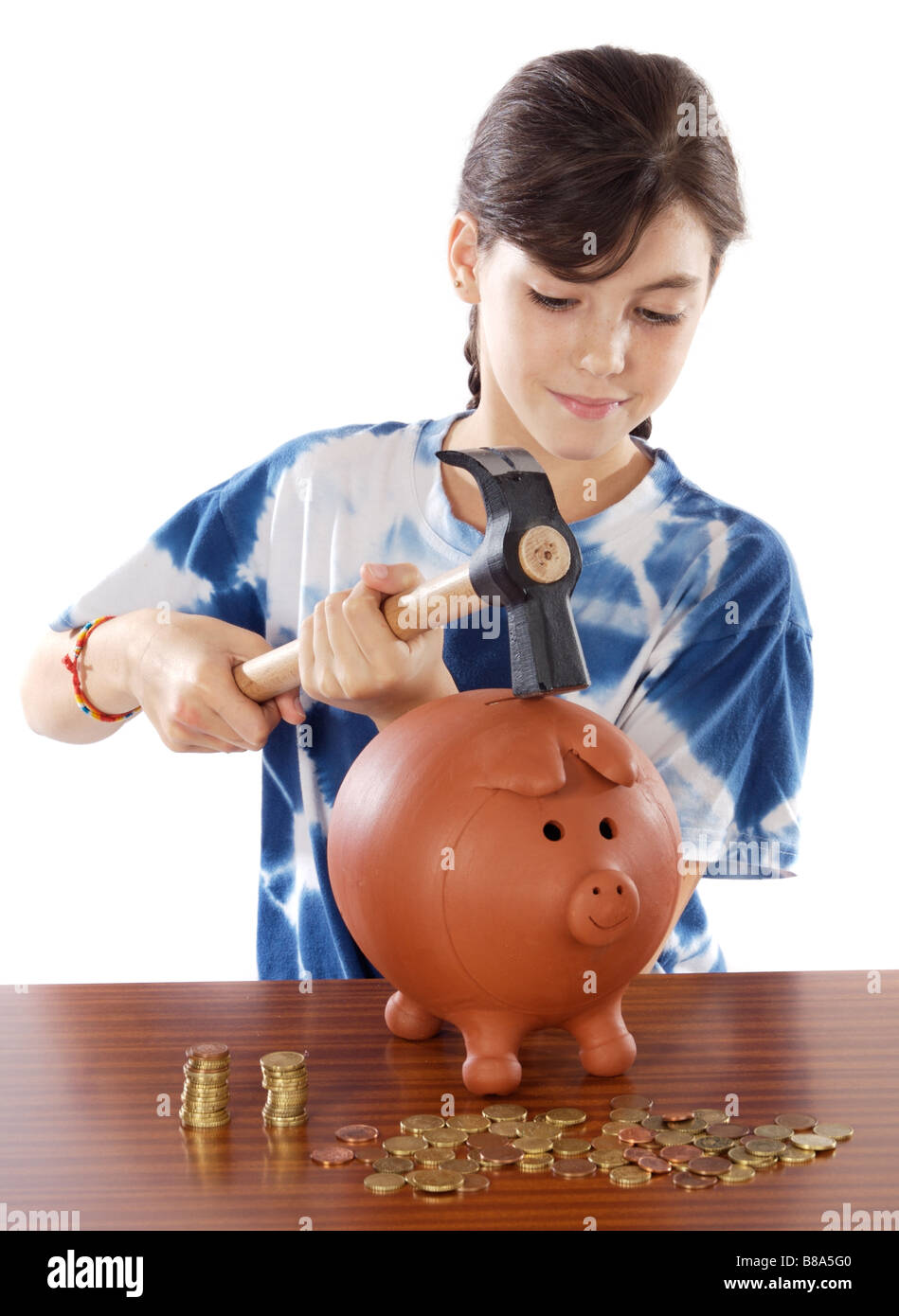 photo of an adorable girl breaking the money box Stock Photo - Alamy