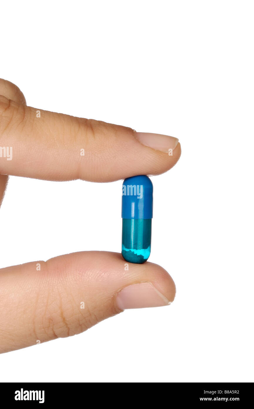 hand with a pill over a white background Stock Photo - Alamy
