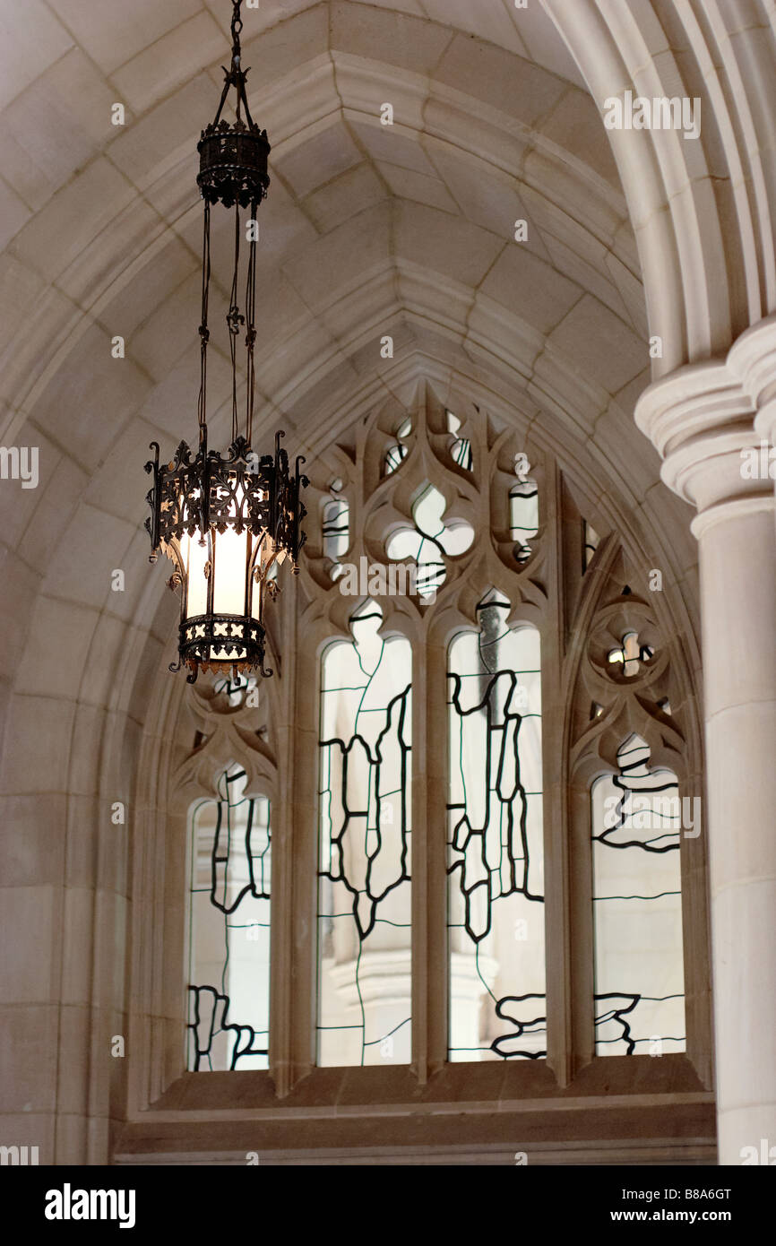 A chandelier and stained glass window in the north cloister of the ...