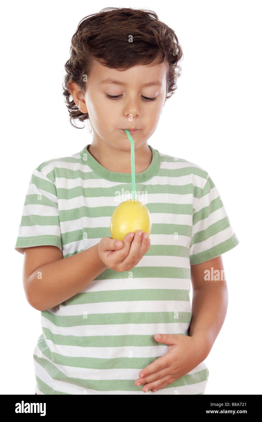 Cute boy eating lemon over a white background Stock Photo - Alamy