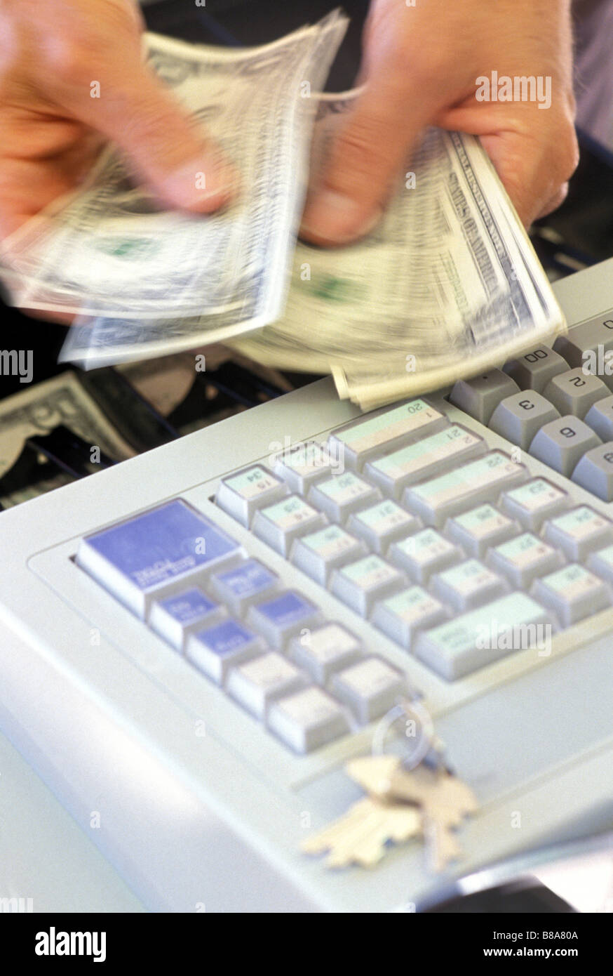 Counting money and cash register Stock Photo - Alamy