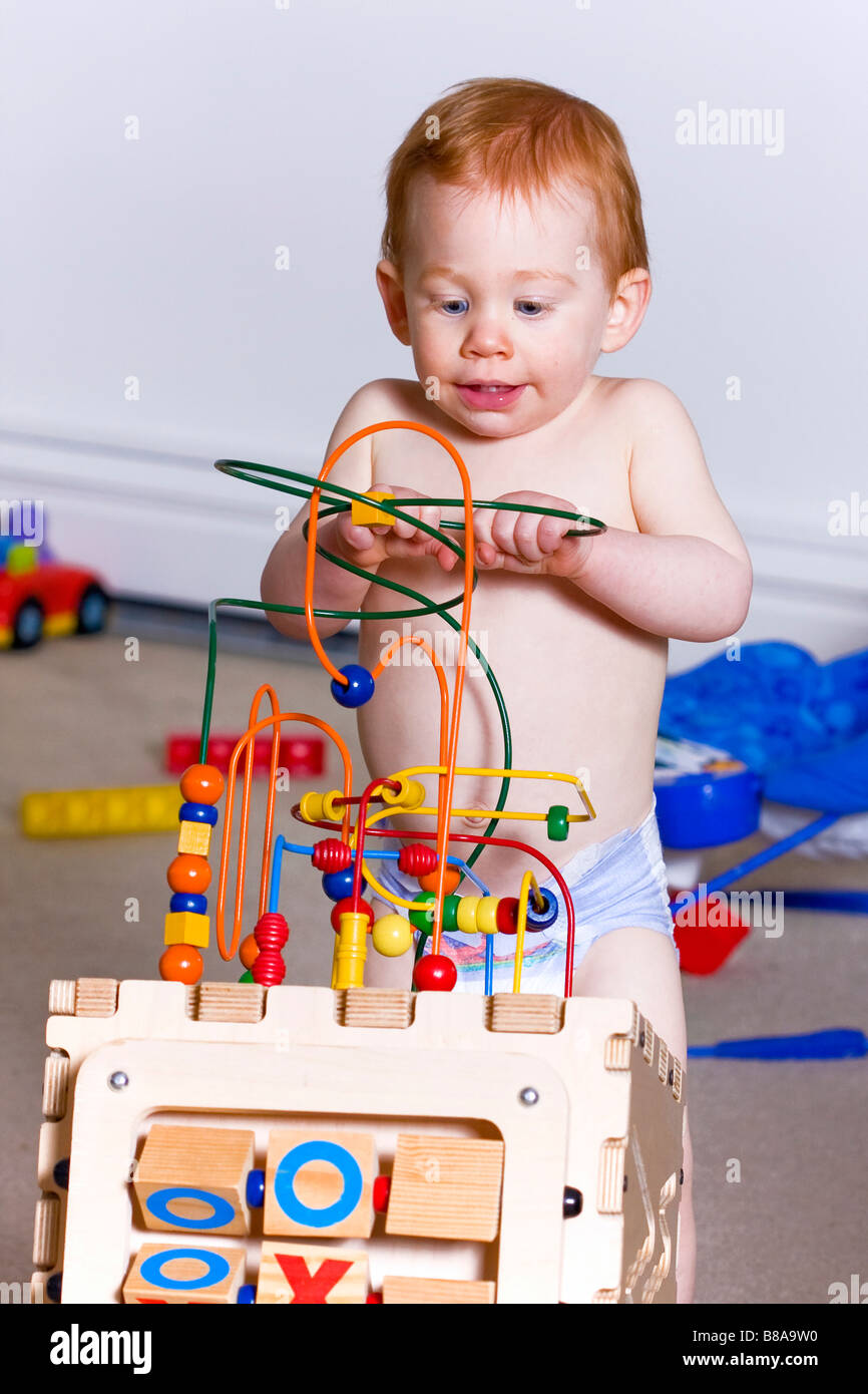 Young baby playing with a children s puzzle toy Stock Photo - Alamy