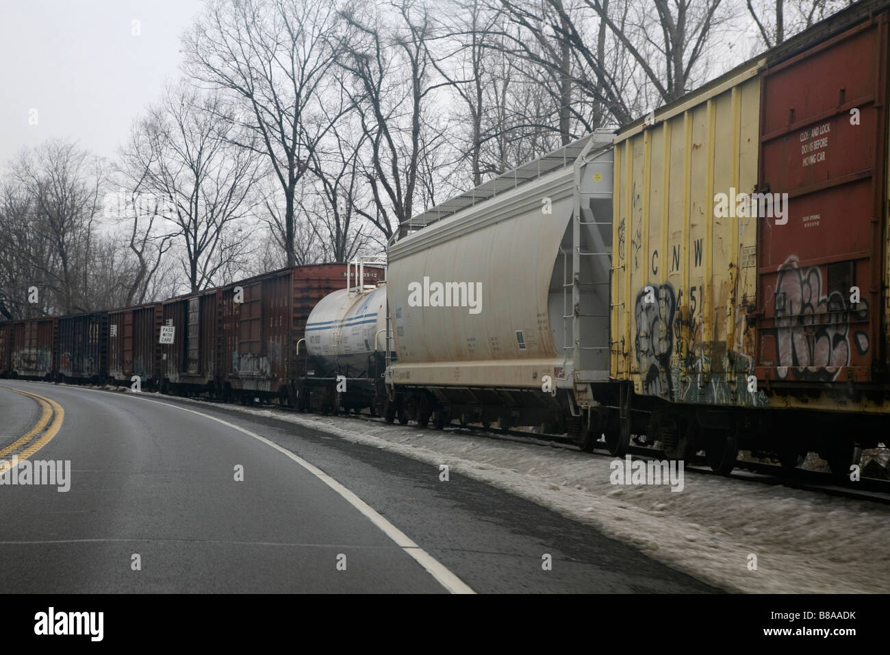 Freight train moving parallel to the highway Stock Photo - Alamy