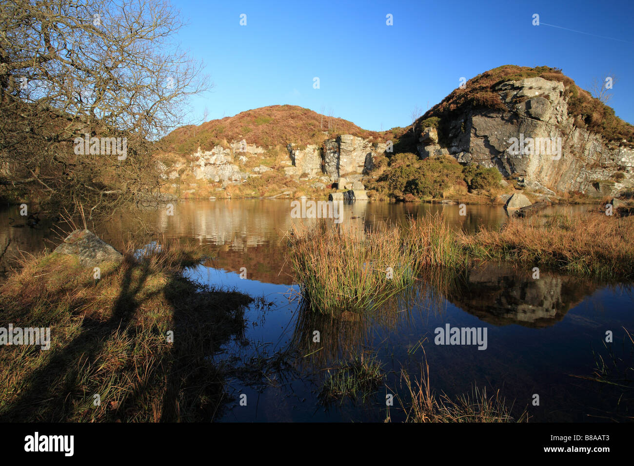 Haytor Quarry on sunny winters days showing reflection in water ...