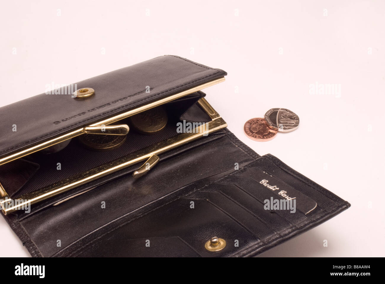 money falling from a purse Stock Photo - Alamy