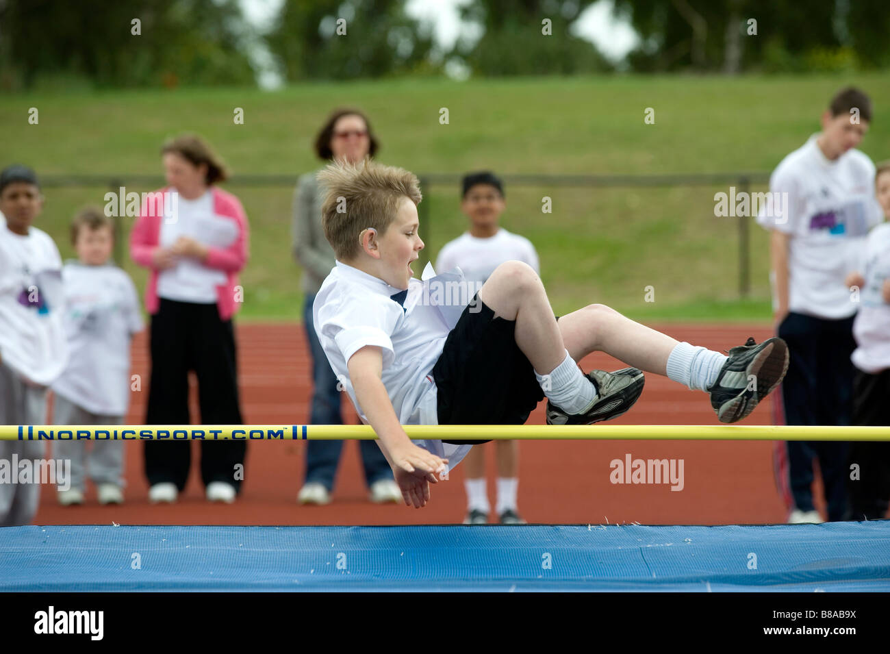 A young boy takes part in the high jump at an athetics meeting ...