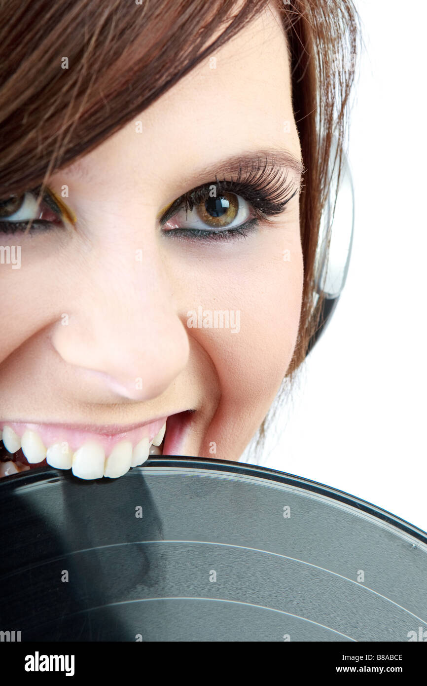 Woman biting on a record Stock Photo - Alamy