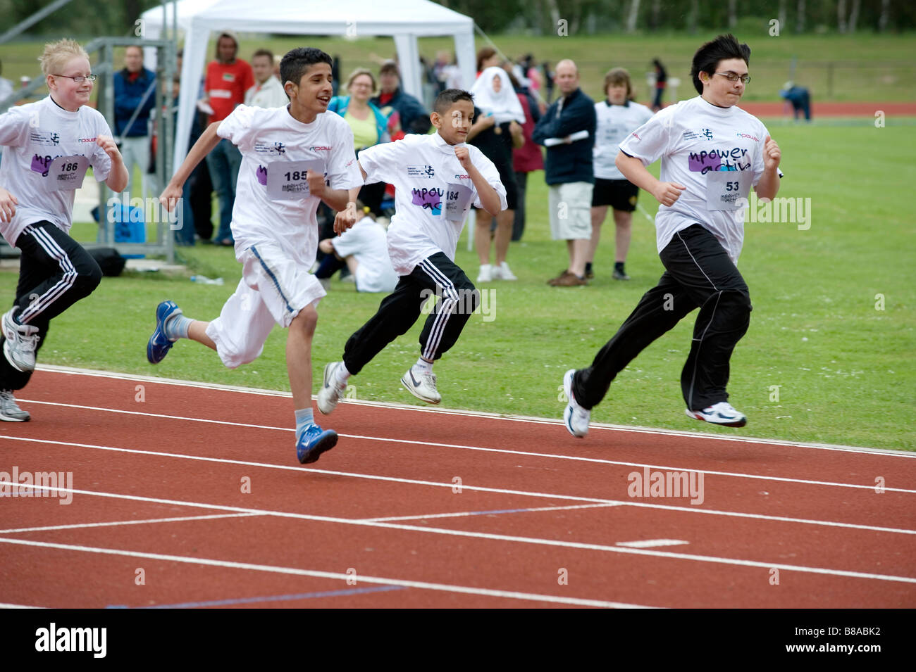 Running race on an athetics track involving children with disabilities ...