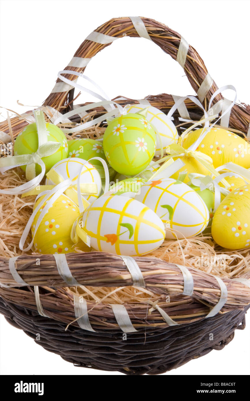 Decorated Easter eggs in a straw lined wicker basket Stock Photo - Alamy