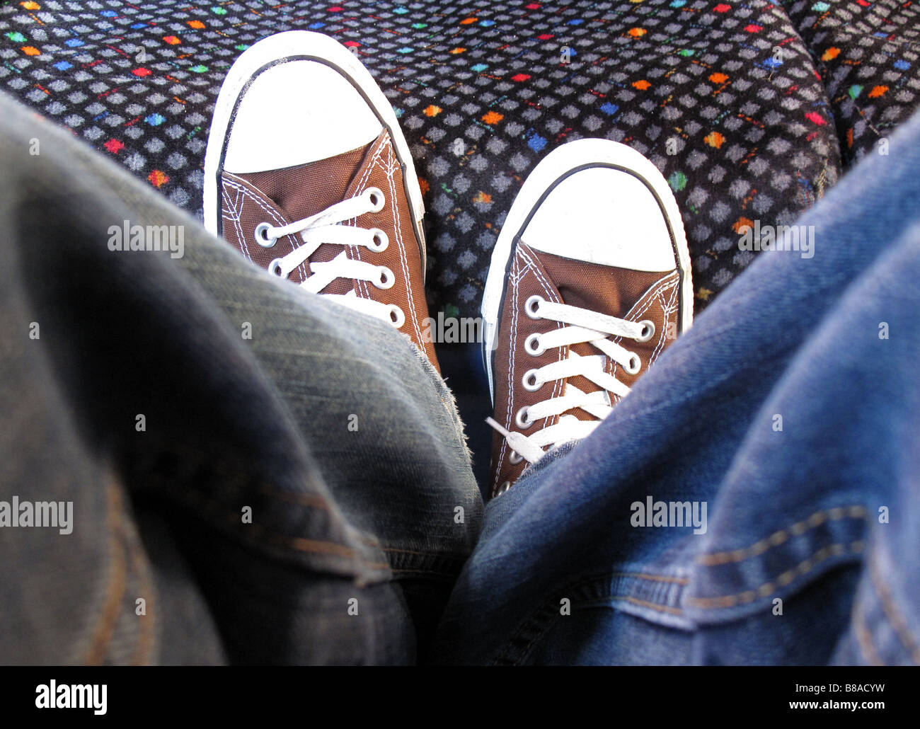 Feet resting on bus seat Stock Photo - Alamy