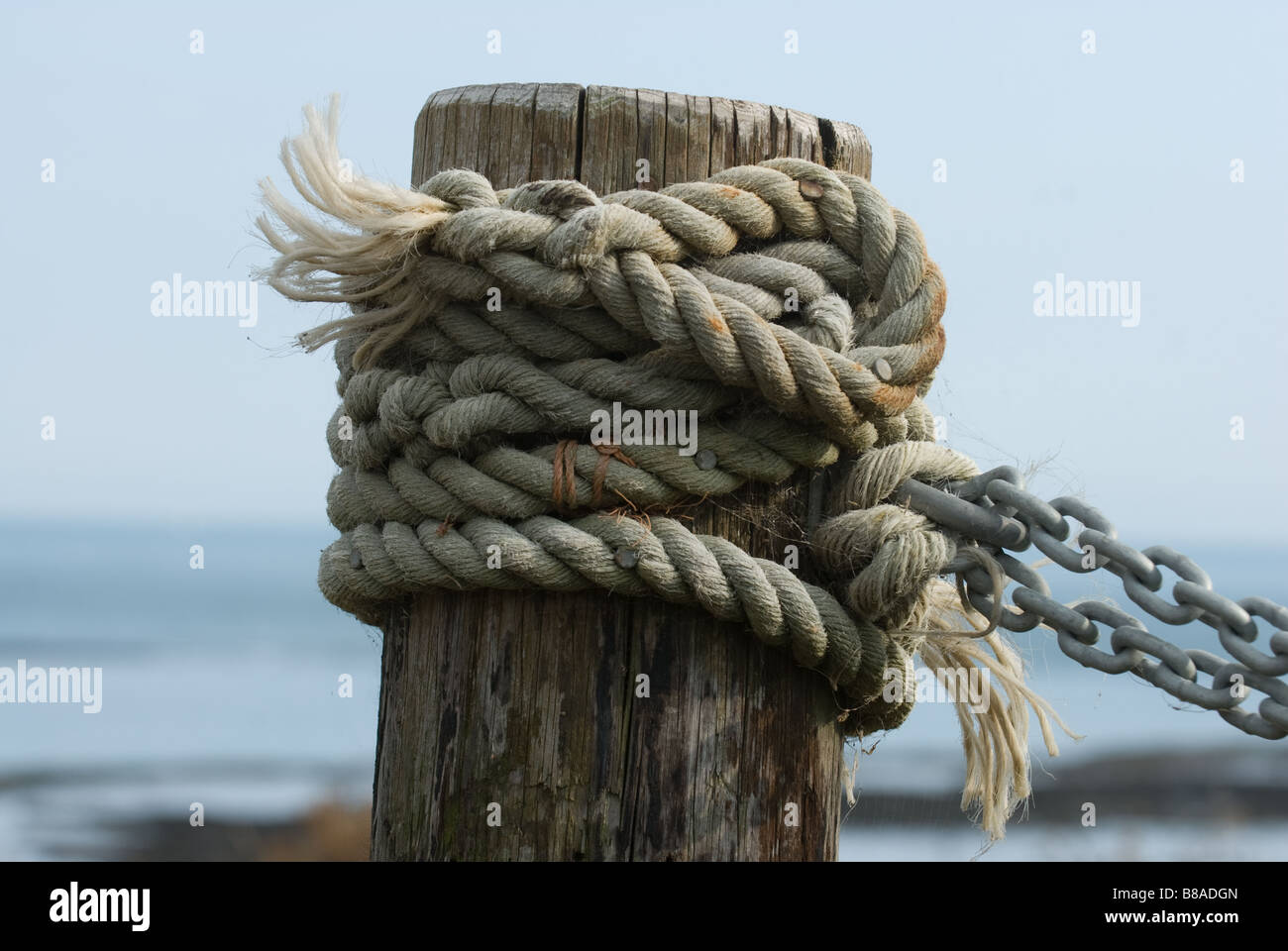 cliff top wooden fence post with rope and chain links Stock Photo - Alamy