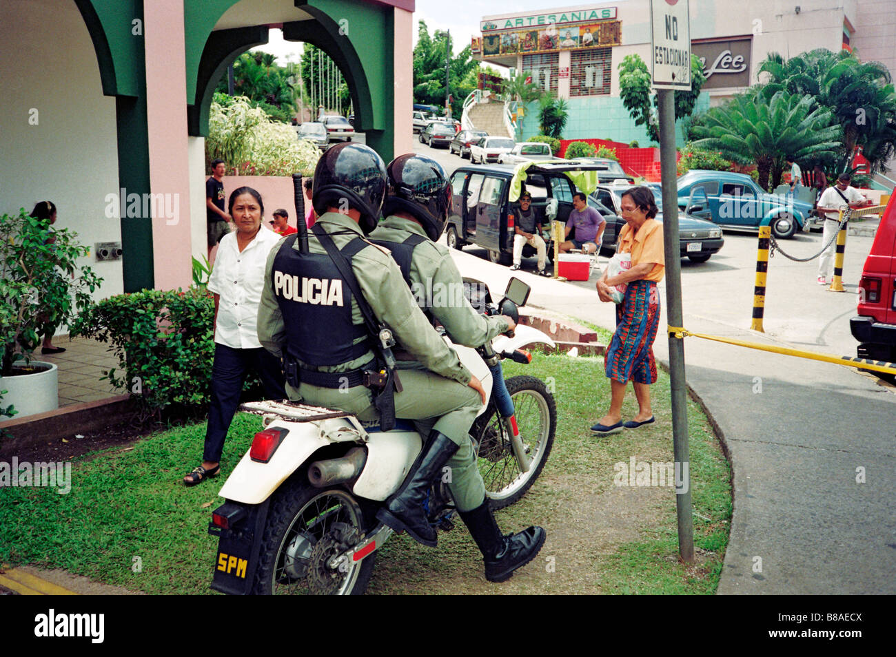 Two Panamanian police officers riding two up on a motorcycle before the ...